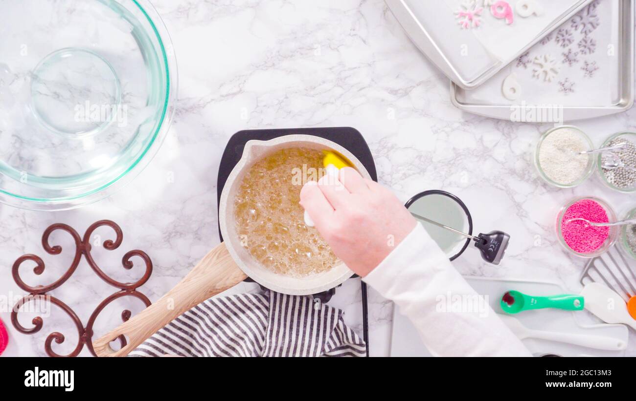 Flat lay. Step by step. Caramelizing sugar in a small cooking pot over ...