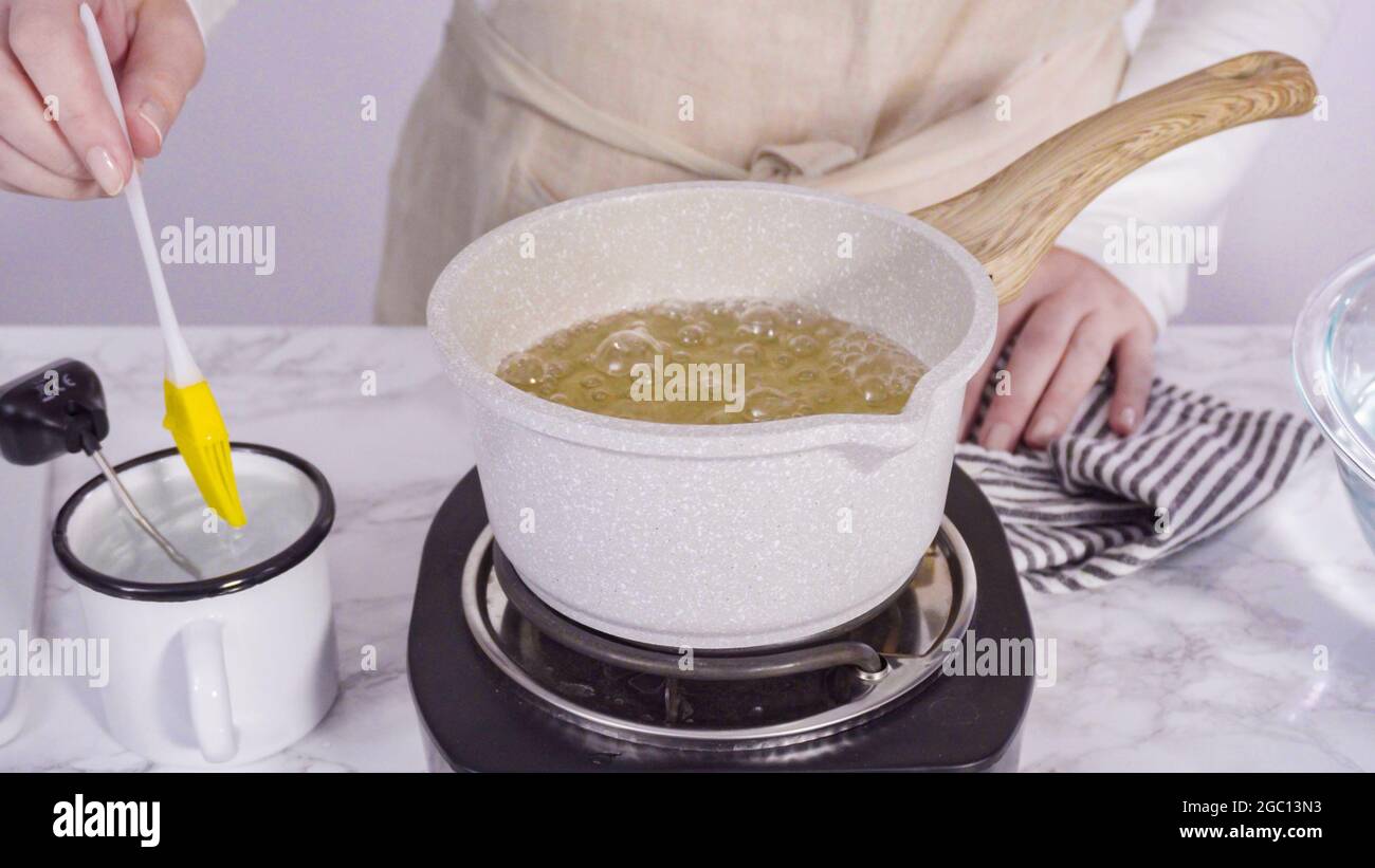 Step by step. Caramelizing sugar in a small cooking pot over the small ...