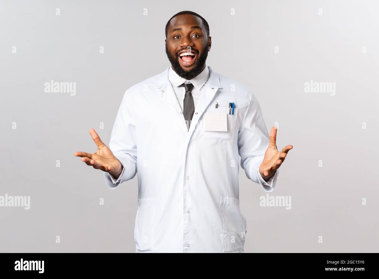 Happy african american doctor at clinic or hospital welcoming patient ...