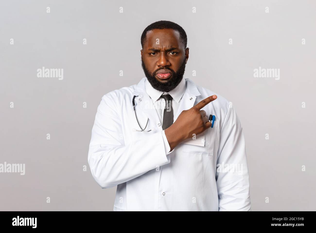 Healthcare, medicine and epidemic concept. Serious-looking angry and ...