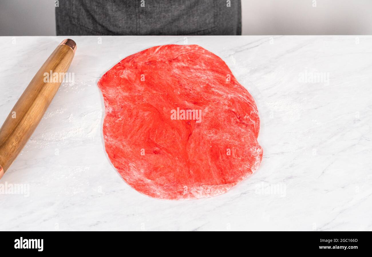 Rolling red and blue bread dough to bake patriotic cinnamon twists ...