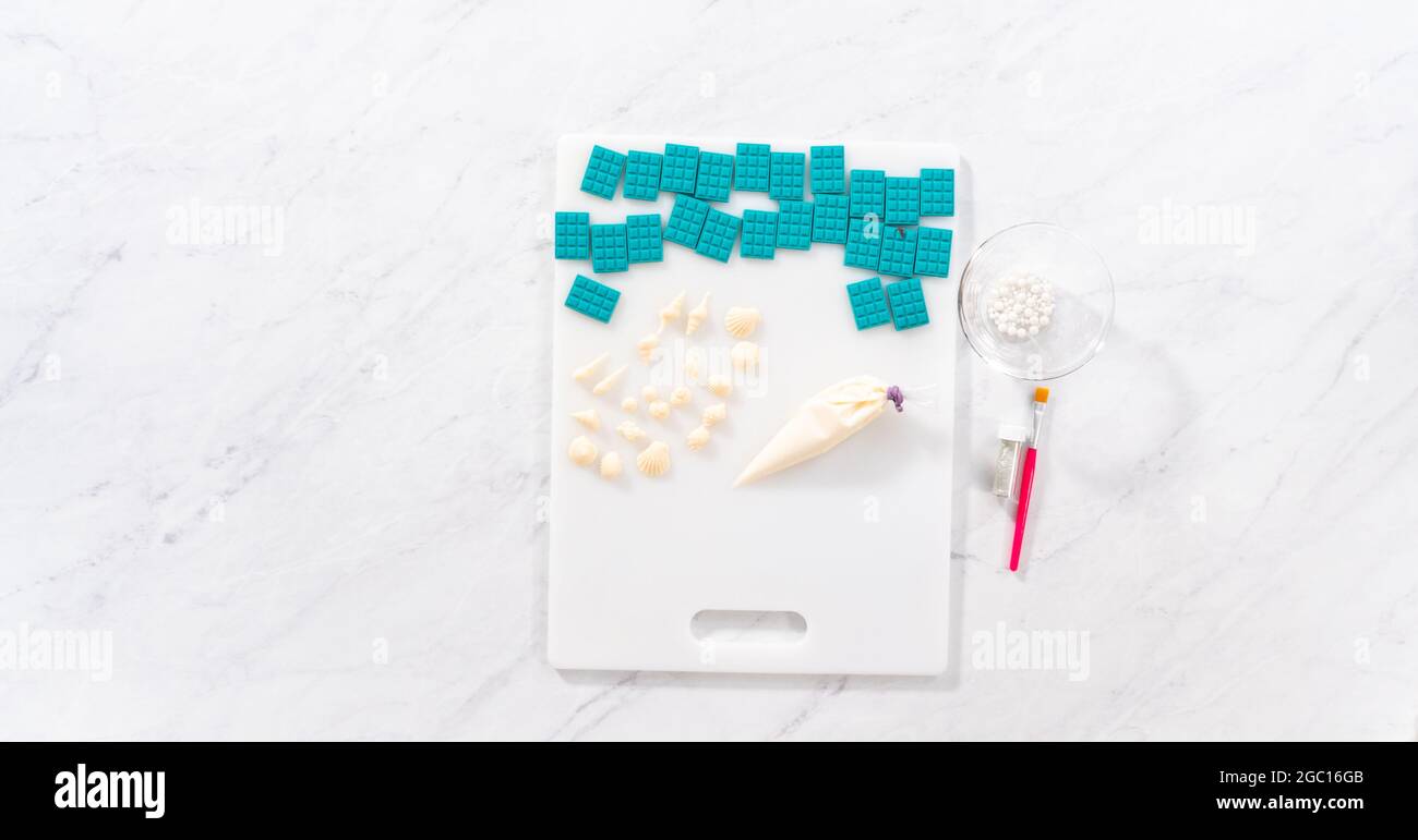 Flat lay. Drizzling melted white chocolate and sprinkling with white ...