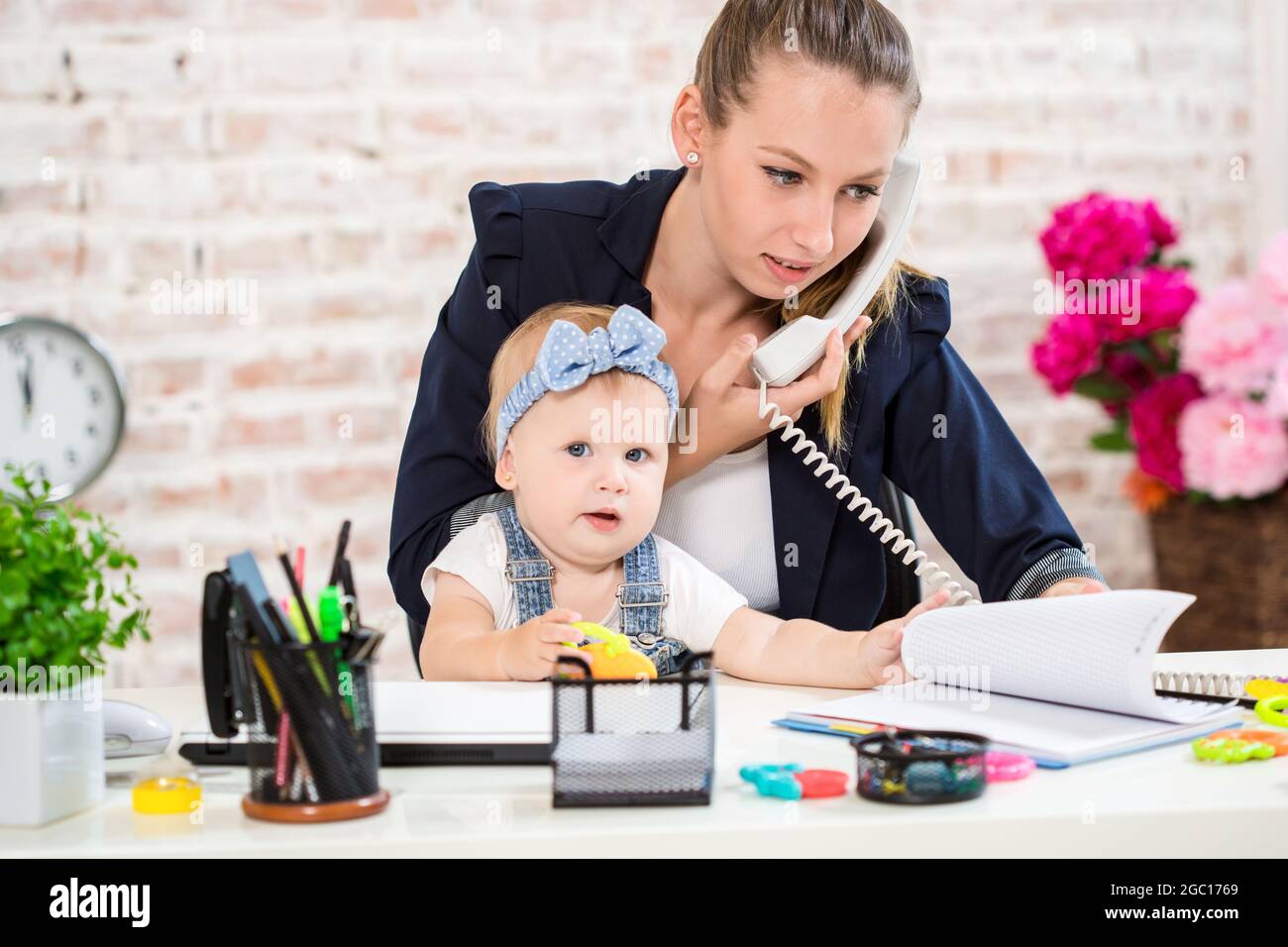 Family Business - telecommute Businesswoman and mother with kid is ...