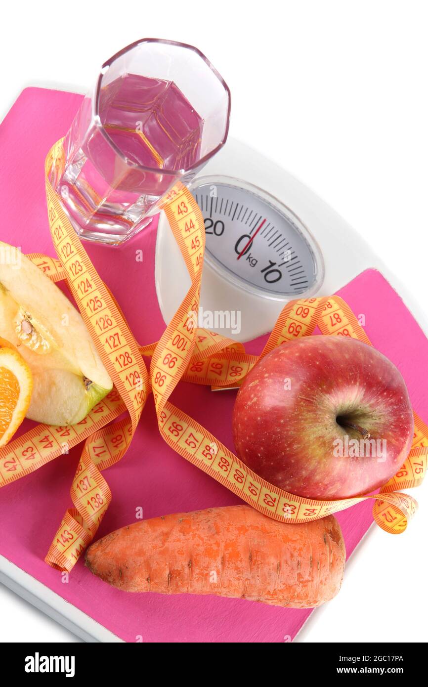 Fruit on scales isolated on white Stock Photo - Alamy