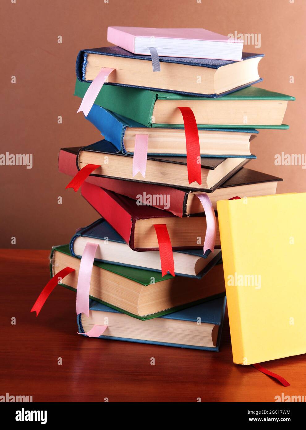 Many books with bookmarks on brown background Stock Photo - Alamy