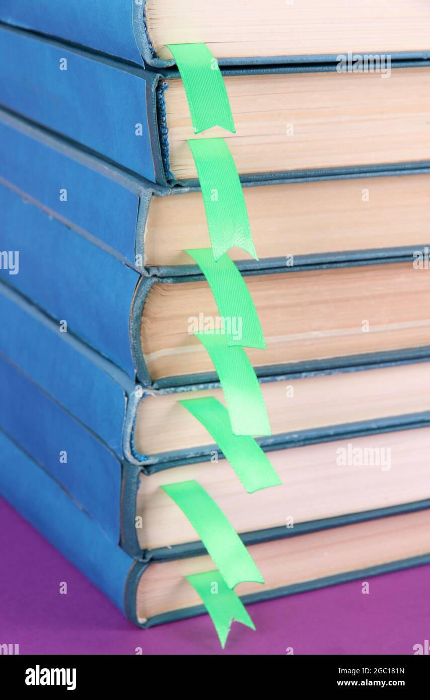 Many books with bookmarks on purple background close-up Stock Photo - Alamy