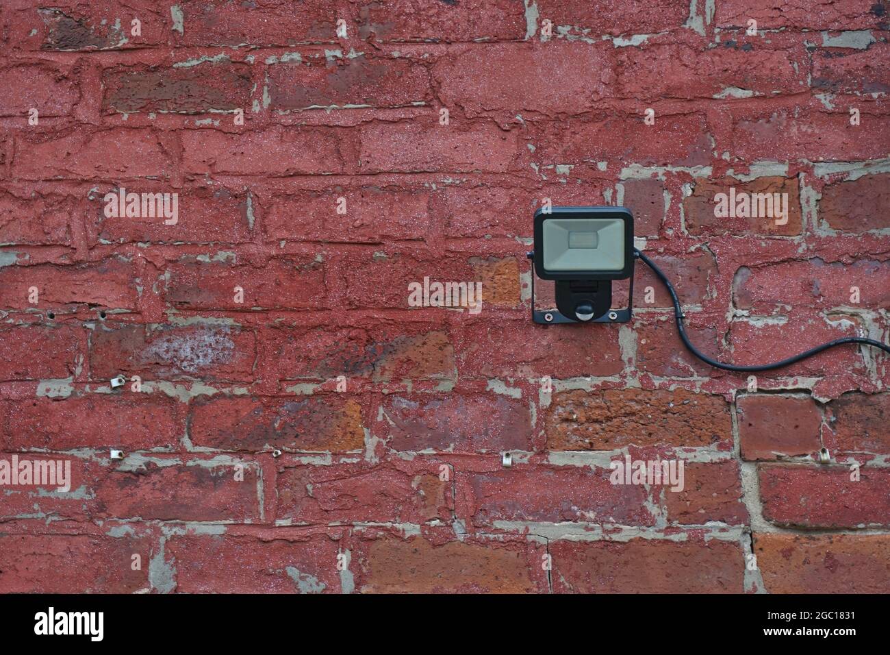 Light with automatic motion sensor on a red brick wall Stock Photo - Alamy