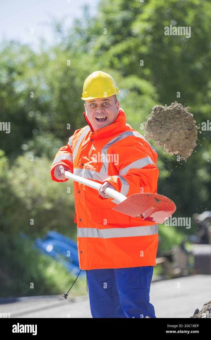 construction worker shoveling sand Stock Photo - Alamy