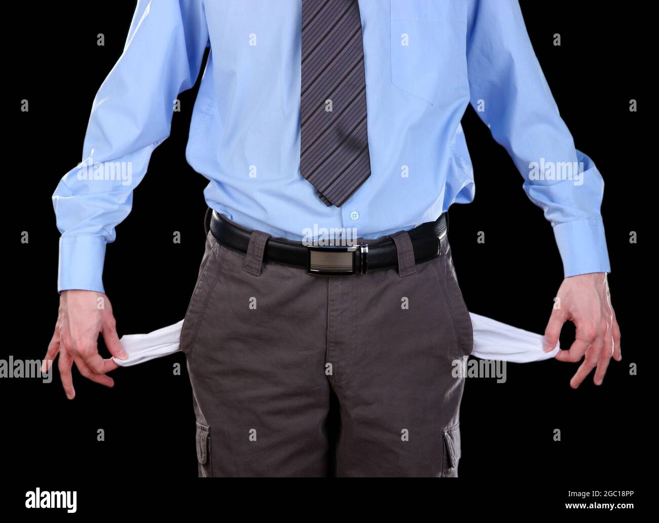 Business man showing his empty pockets, on black background Stock Photo ...