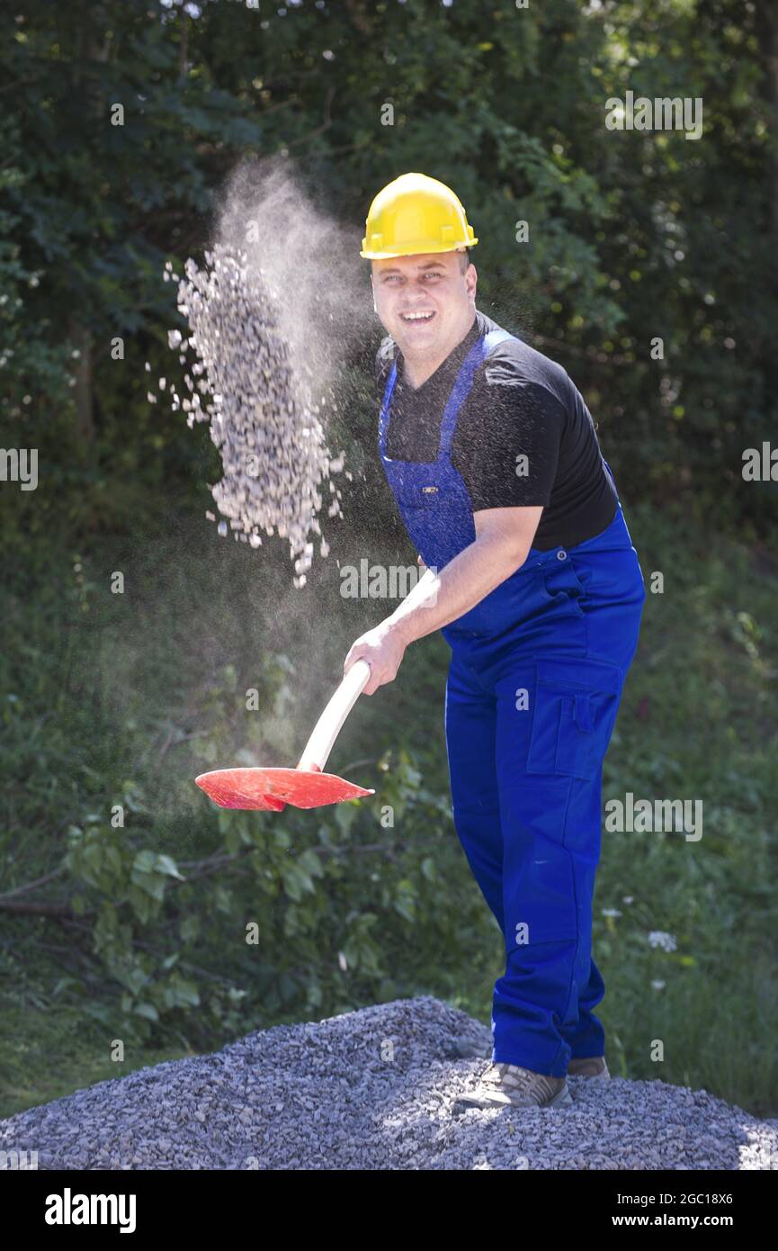 construction worker shoveling sand Stock Photo - Alamy