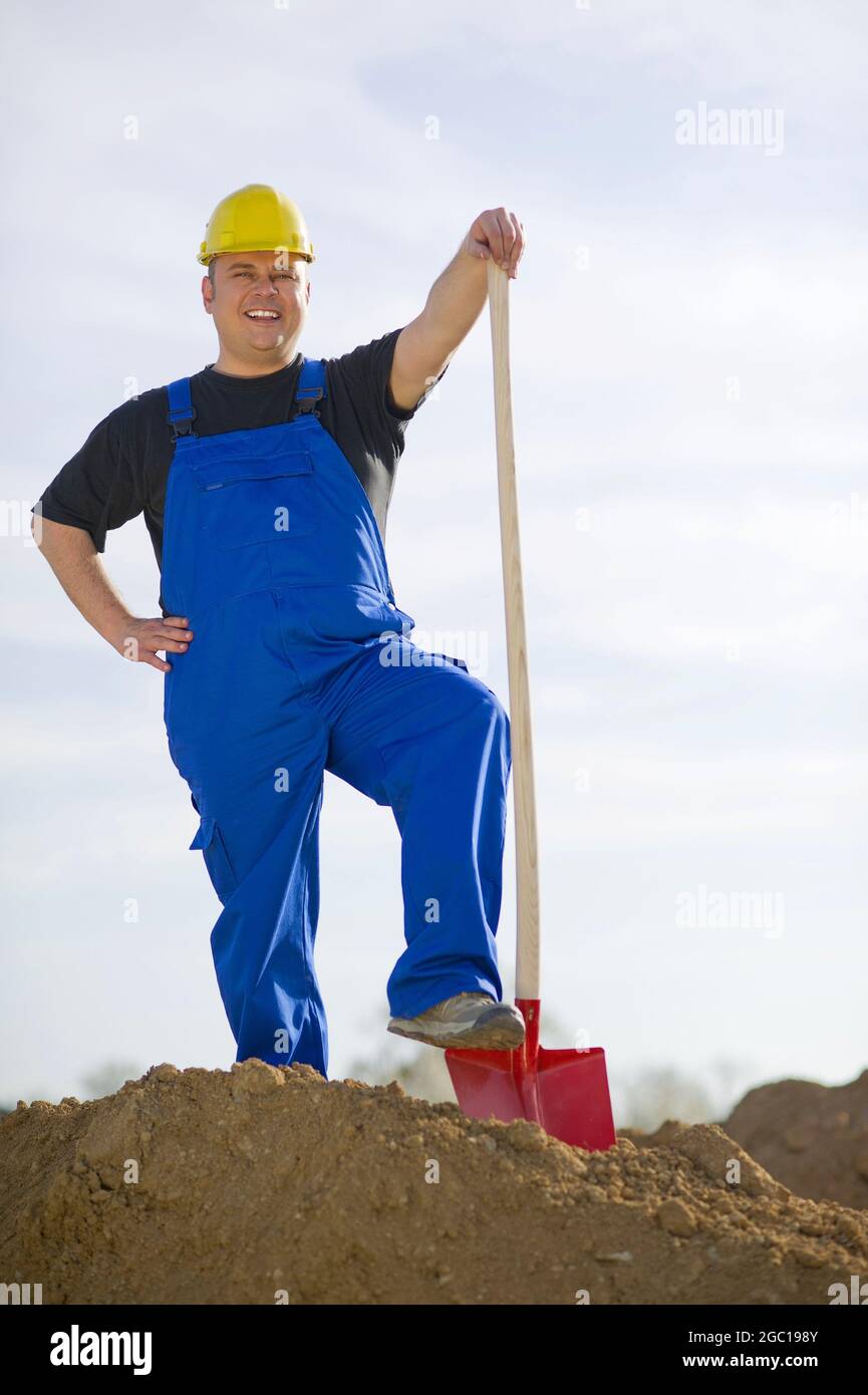 construction worker shoveling sand Stock Photo - Alamy
