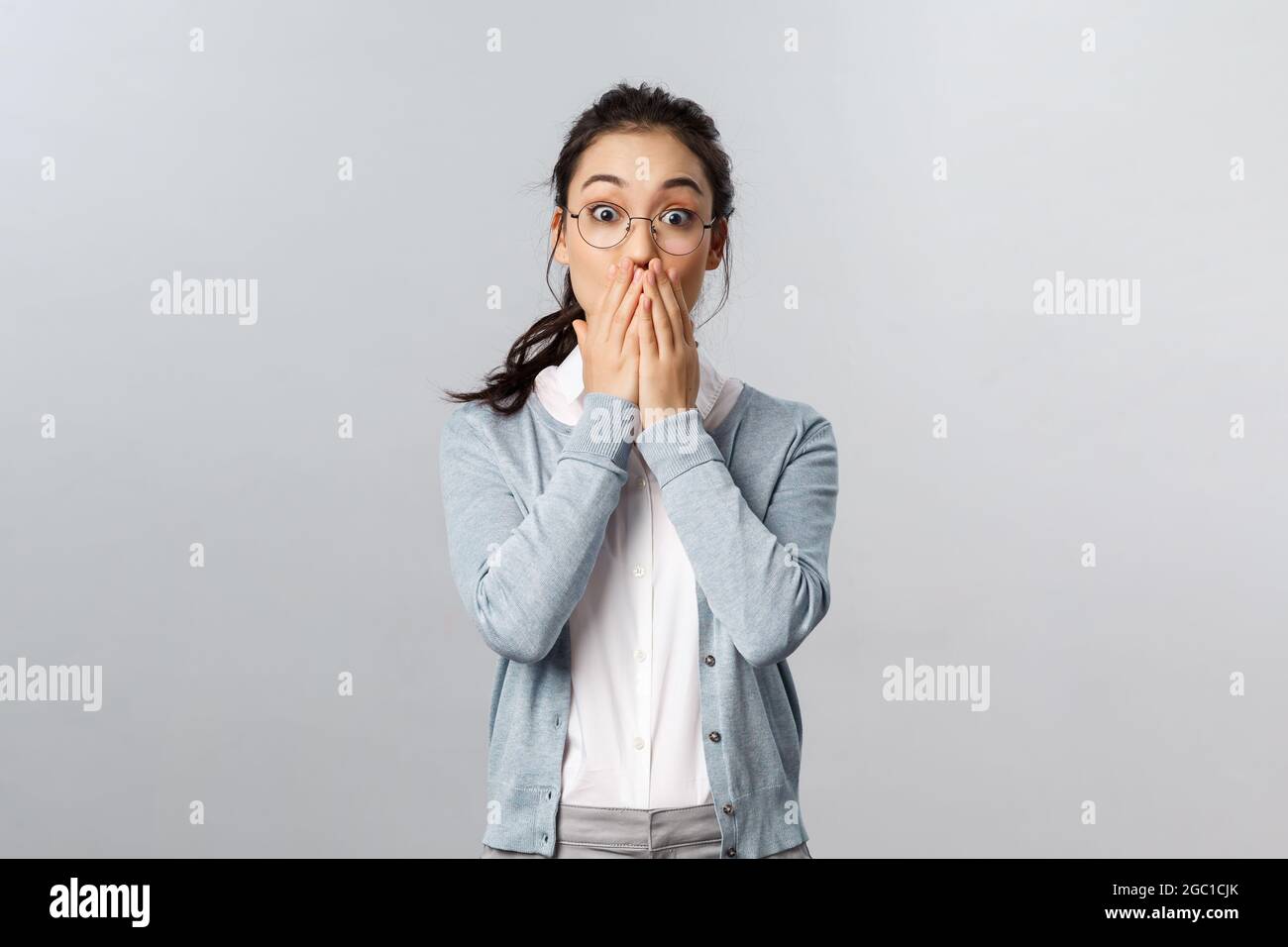 Shocked, speechless attractive asian woman gasping and cover mouth in ...