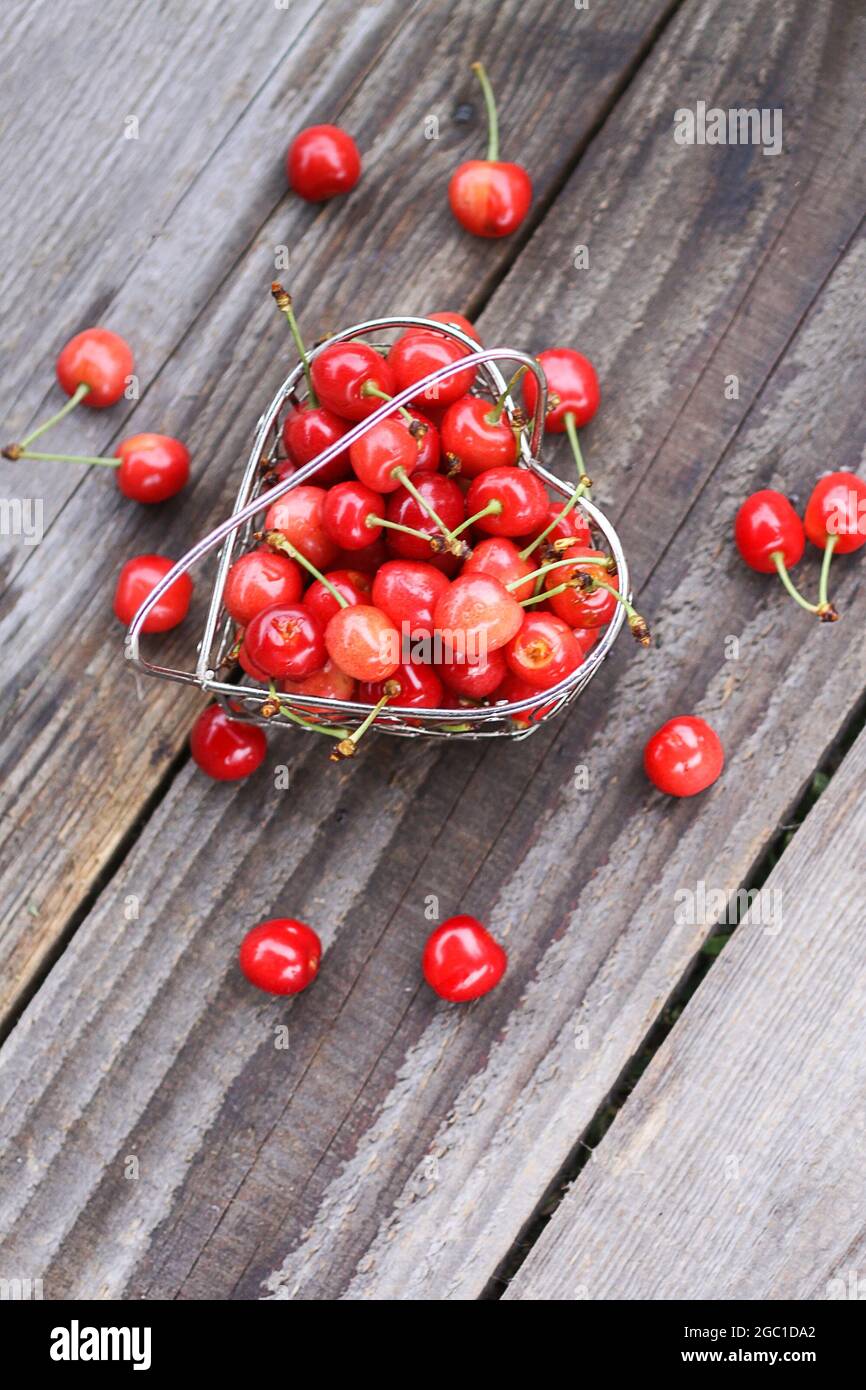 Cherry in small metal basket on wooden surface. Ripe fresh organic ...