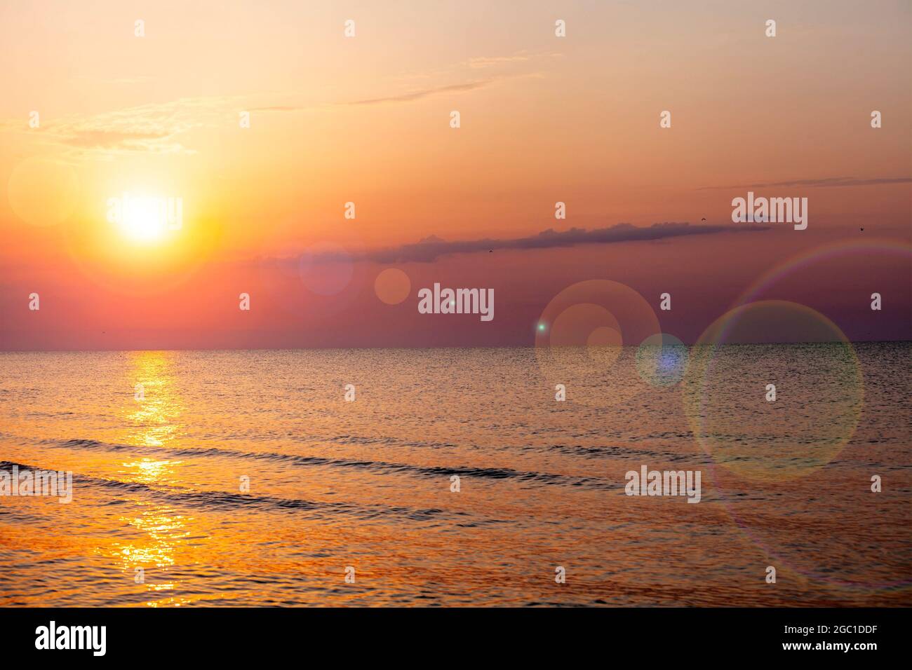 Sun ray in nature. Golden sunshine in sunrise with water and waves ...