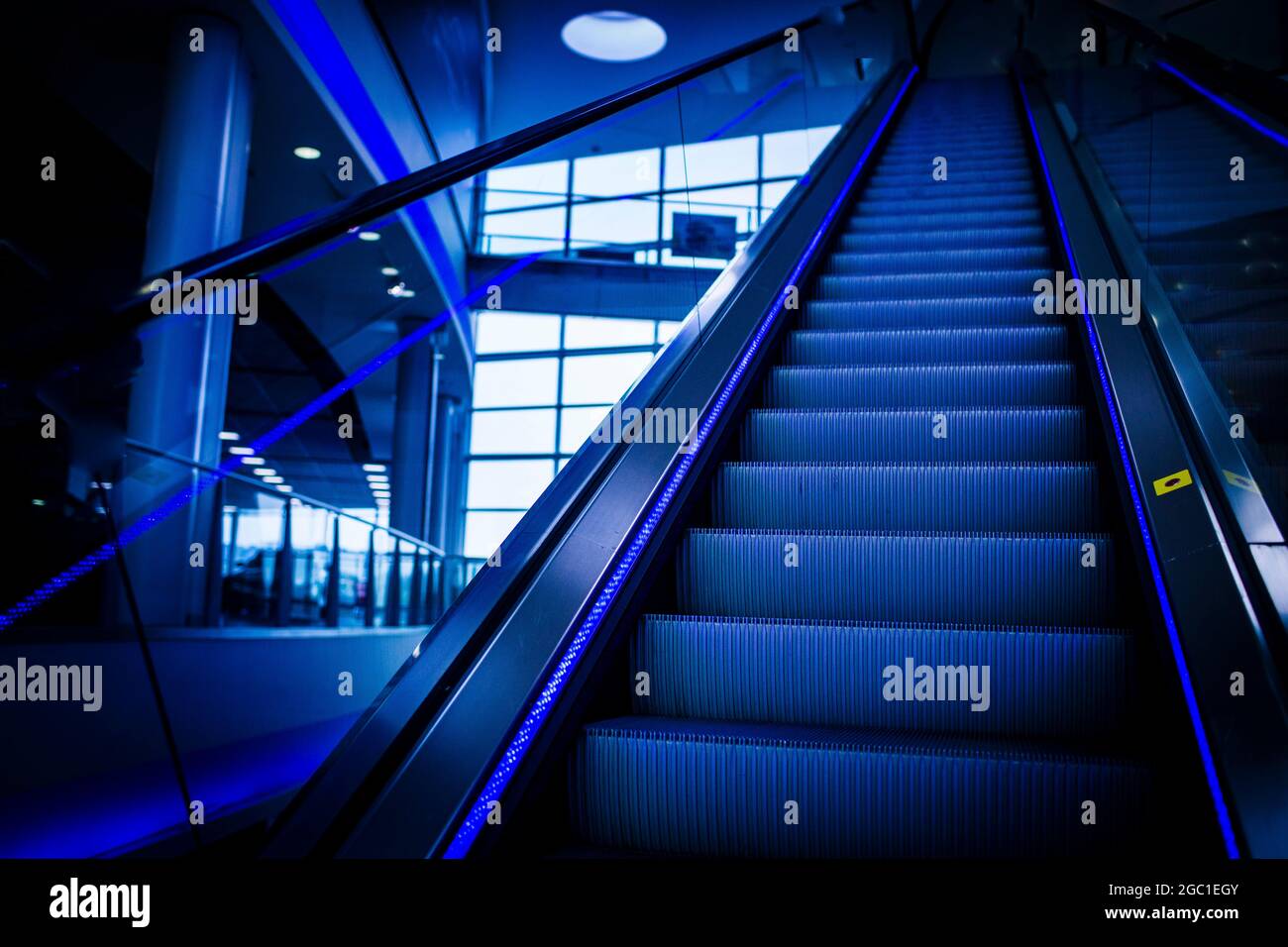 Blue escalator in a corporate building in the UK Stock Photo - Alamy