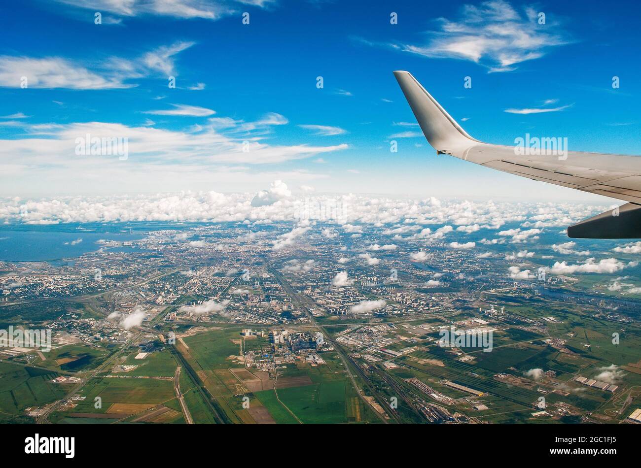 View of the wing of the plane in the porthole on the city and the ...