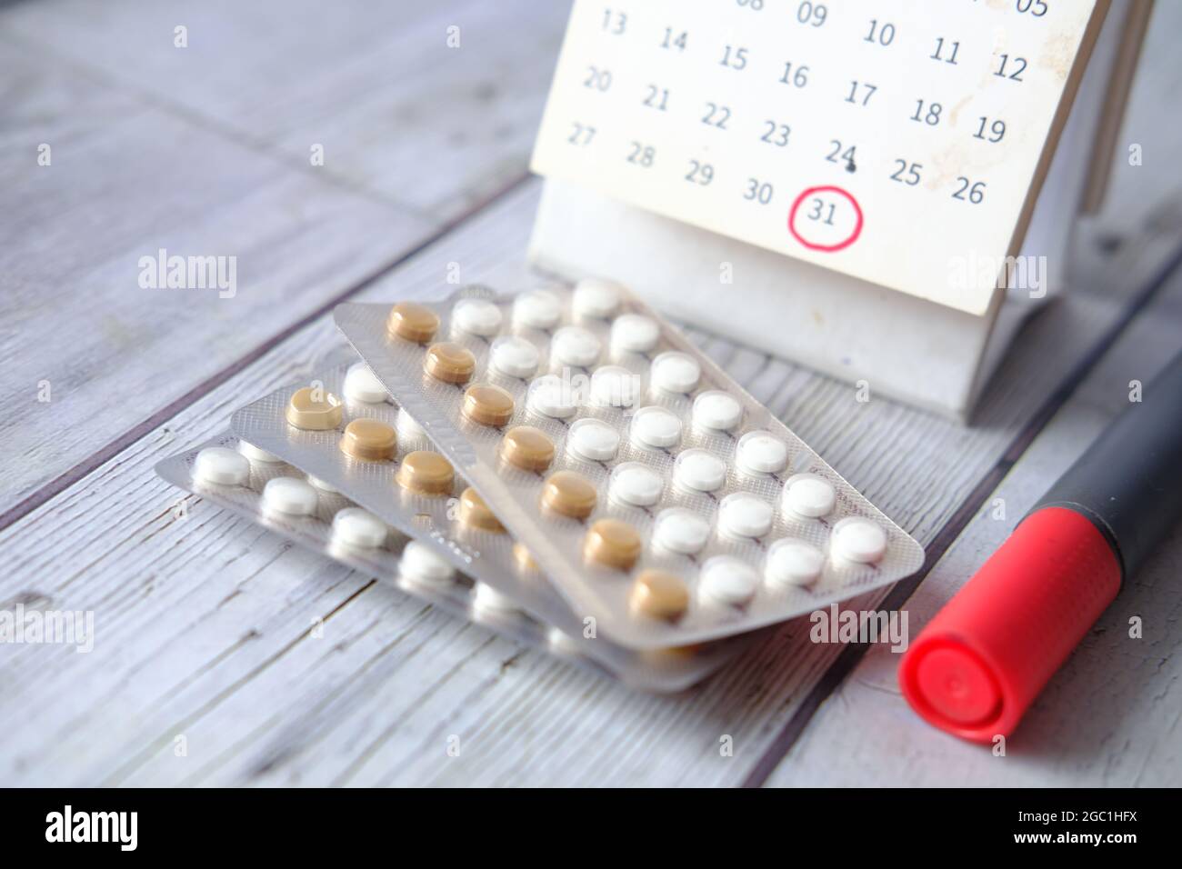 birth control pills , calendar and notepad on table Stock Photo - Alamy