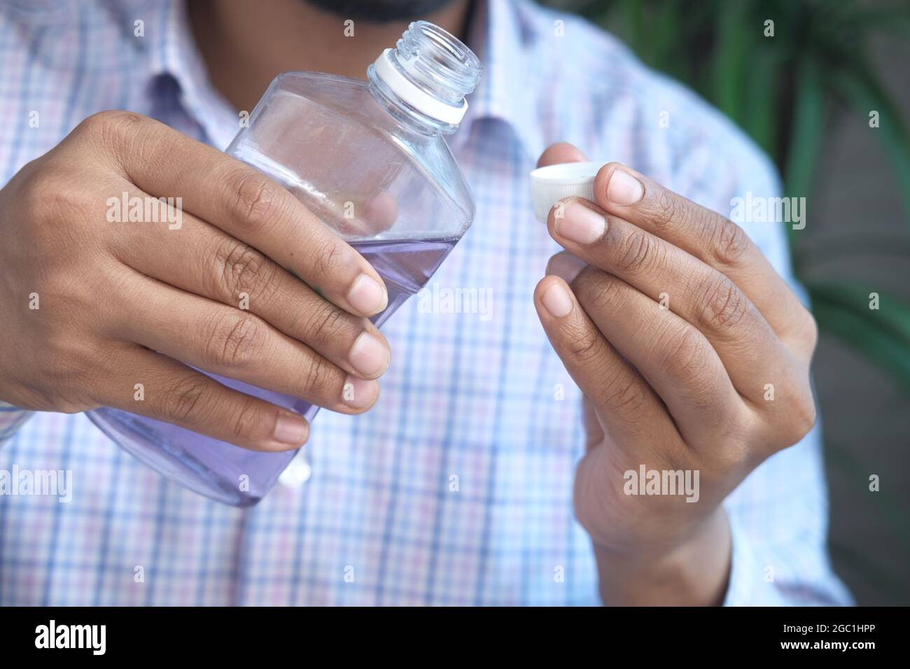 mouthwash liquid flowing into a cap Stock Photo - Alamy