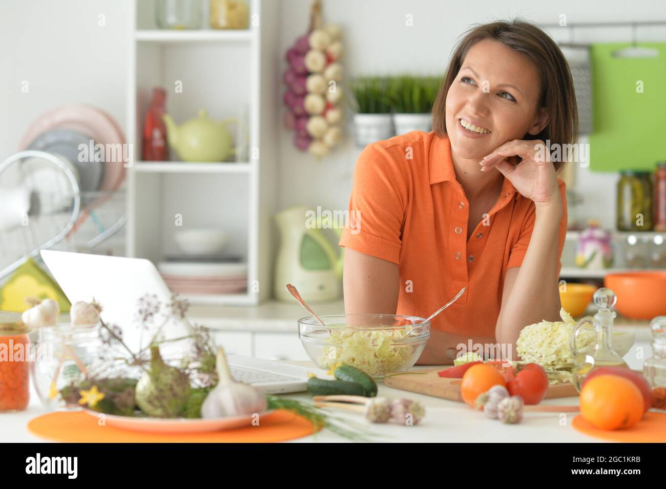 Portrait of beautiful young woman cooking in kitchen Stock Photo - Alamy