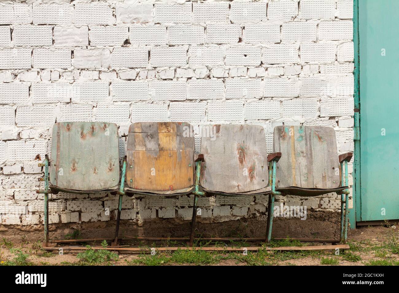 Old rusty movie theater chairs stand against a brick wall Stock Photo ...