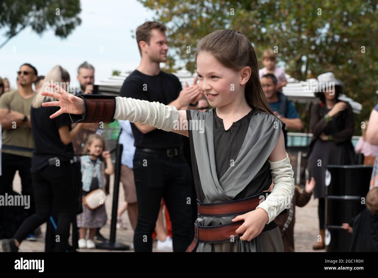 A young girl dress as Rey from the "Force Awakens" strikes a pose ...