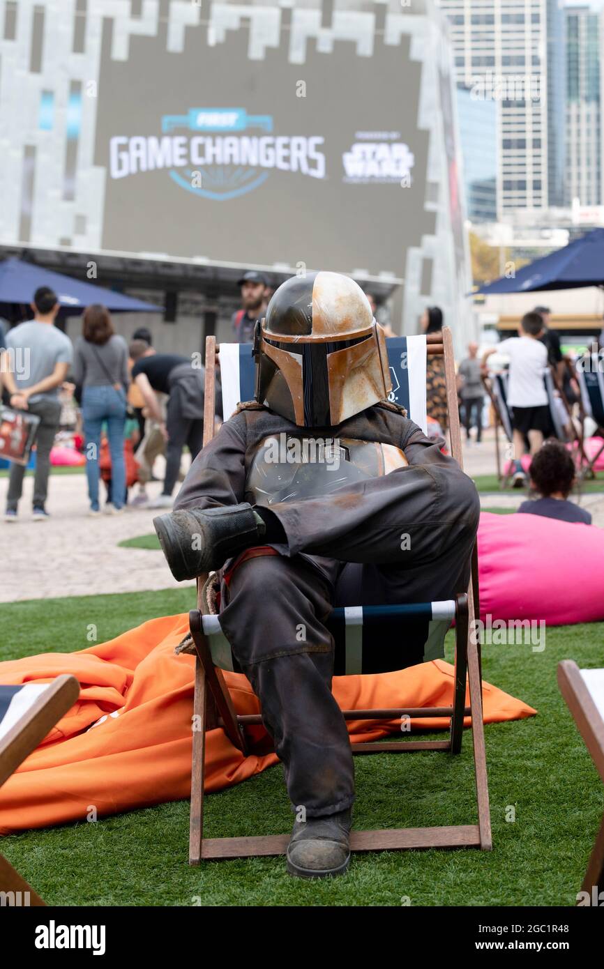 A fan dressed in Mandalorian armor poses in a deck chair during an ...