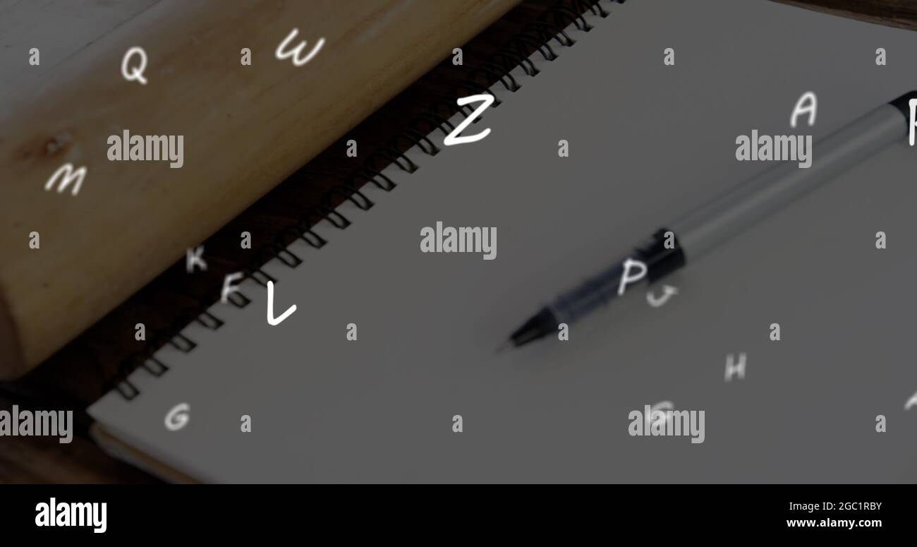 Image of floating letters over a pen lying on a notebook Stock Photo ...