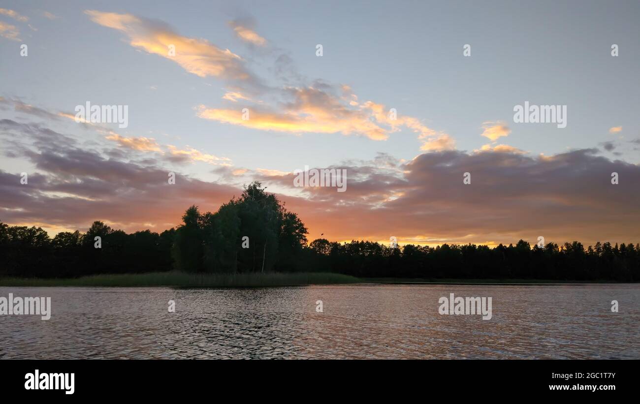 Lake in Latvia with small island. Summer landscape with calm water ...