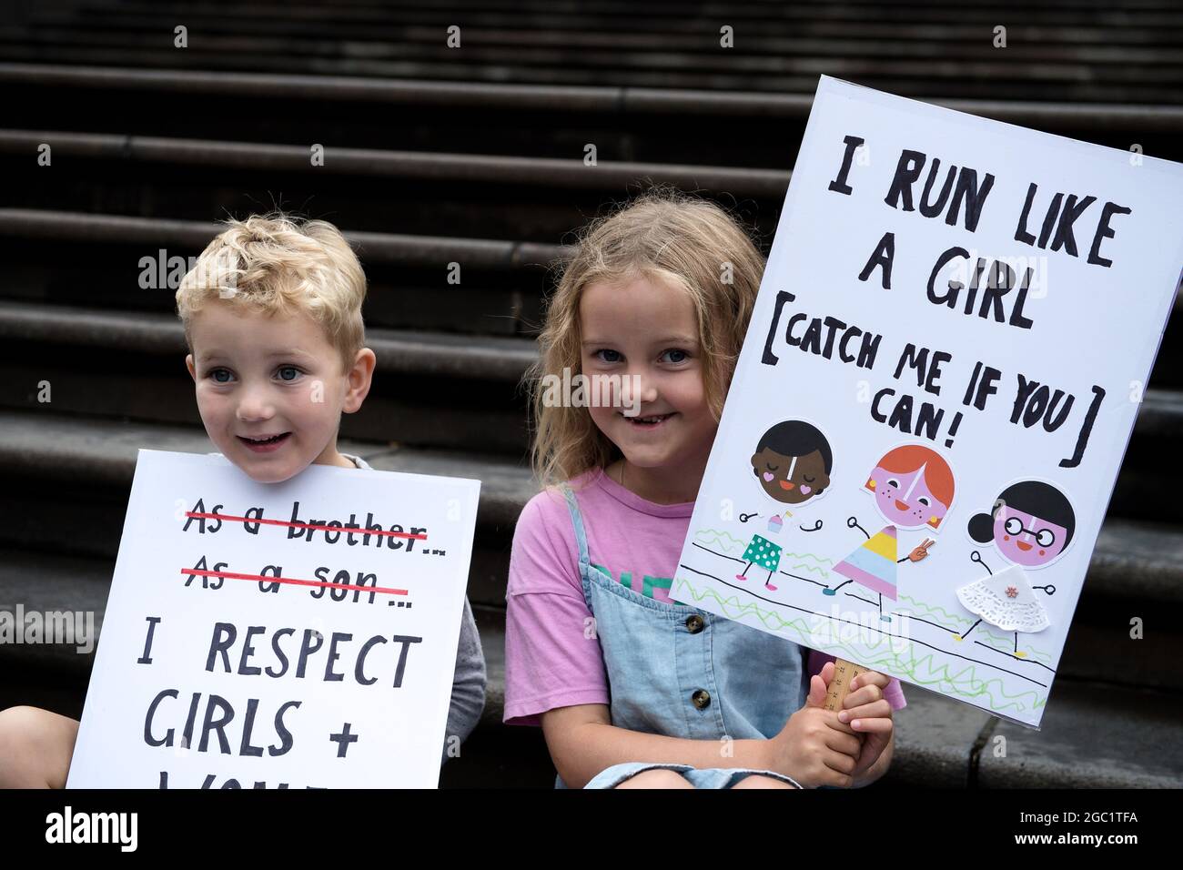Teddy and Evie show off their protest signs during a rally and march of ...