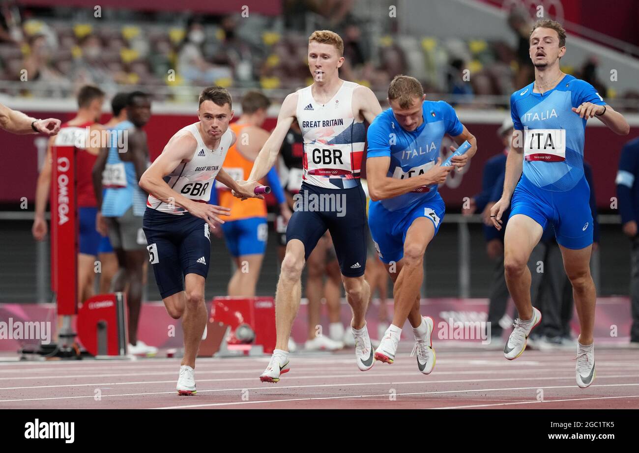 Great Britain's Joseph Brier (left) receives the baton from team-mate ...