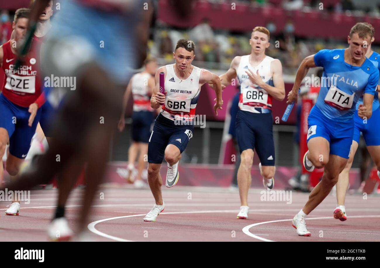 Great Britain's Joseph Brier (left) receives the baton from team-mate ...