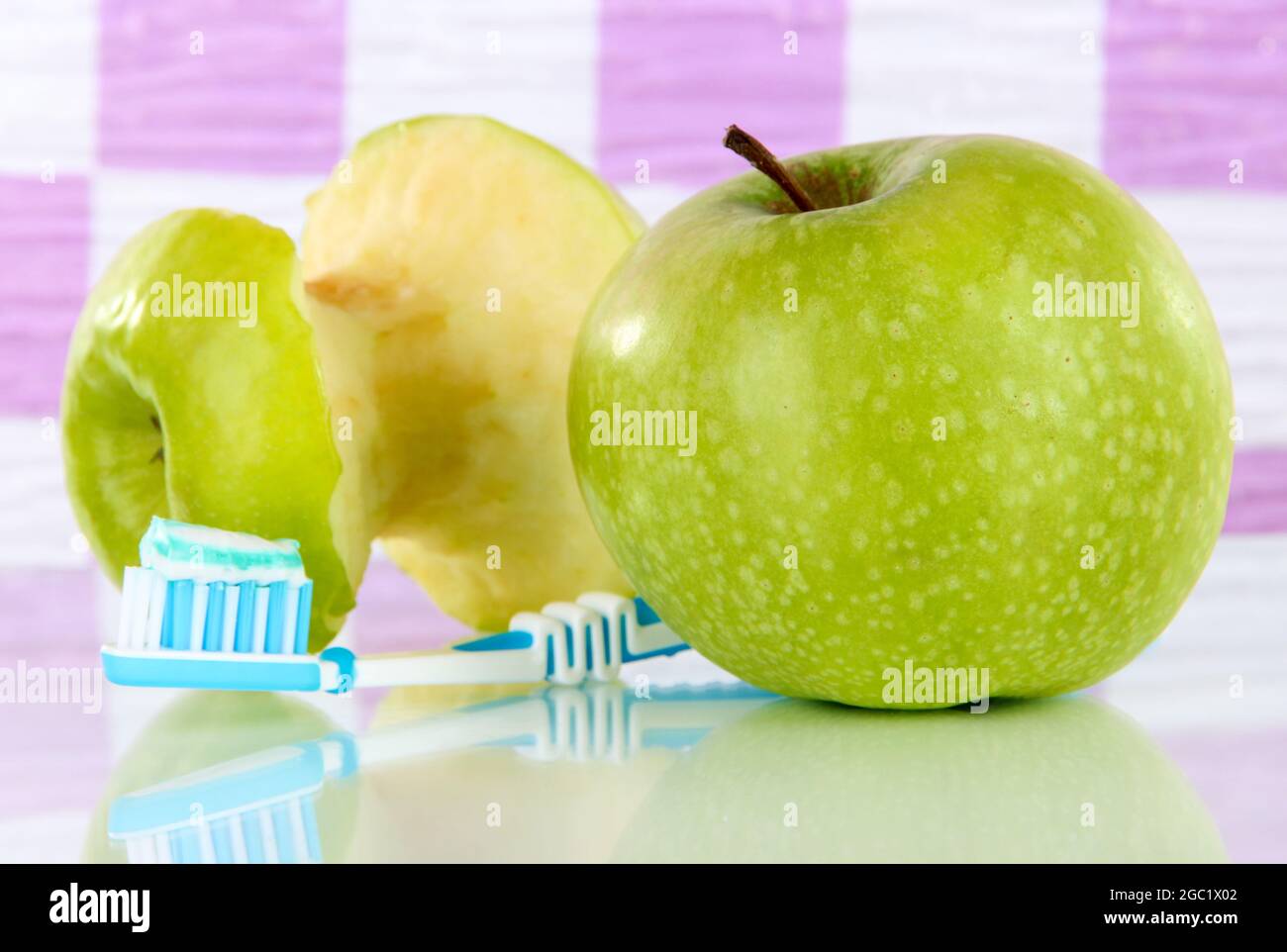 Apples with a toothbrush on shelf in bathroom Stock Photo - Alamy