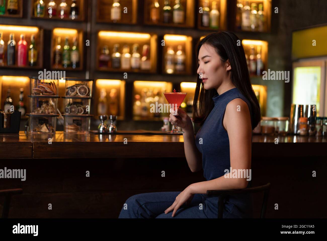 Nightlife concept a pretty girl with long hair wearing blue dress ...