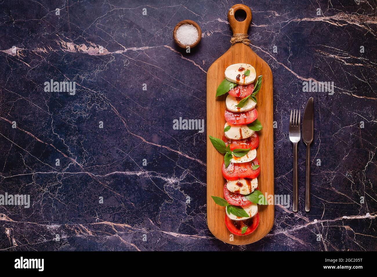 Italian caprese salad with sliced tomatoes, mozzarella, basil, olive ...
