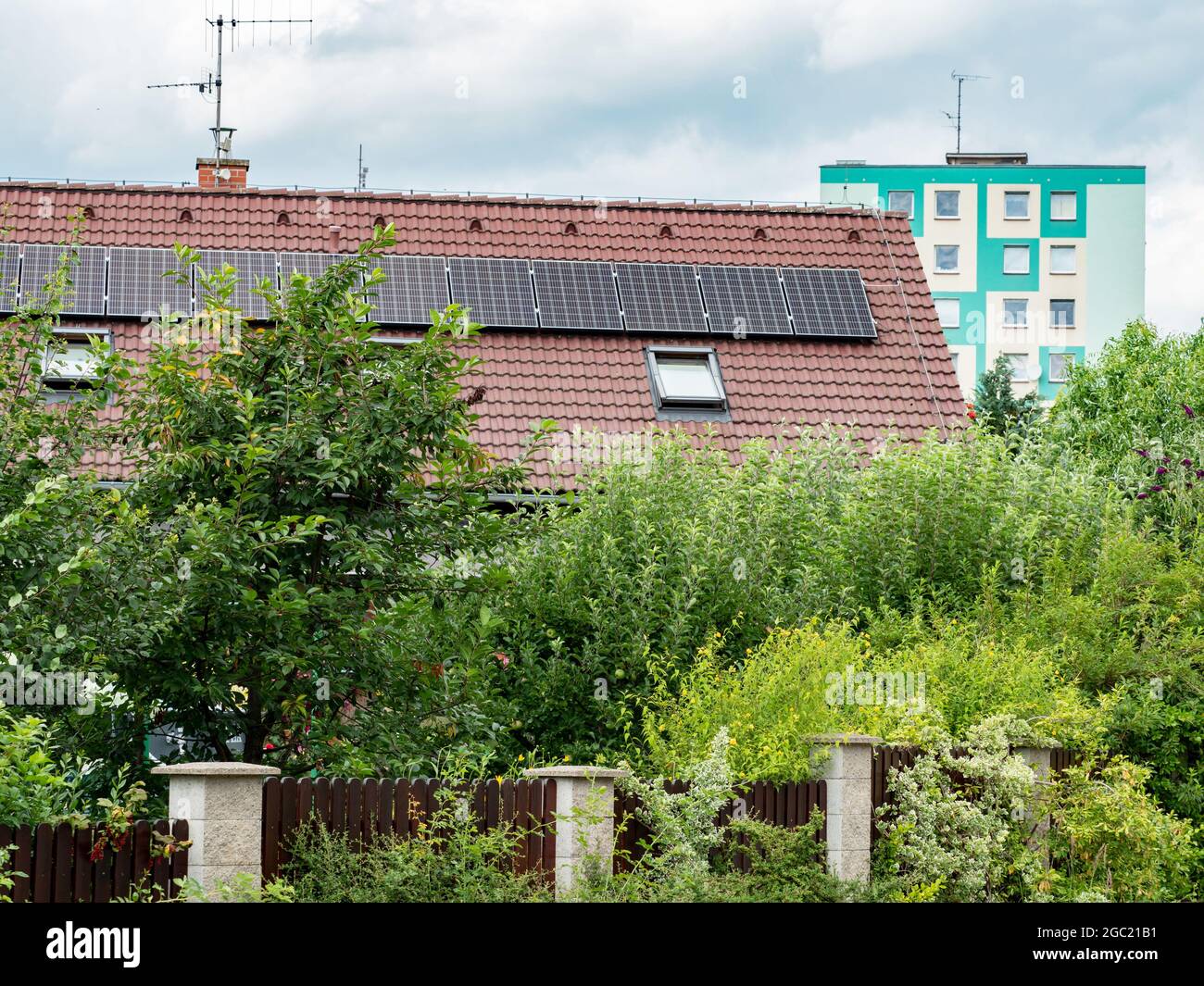 Common solar panels on modern roof with dark blue photocell, replacing ...