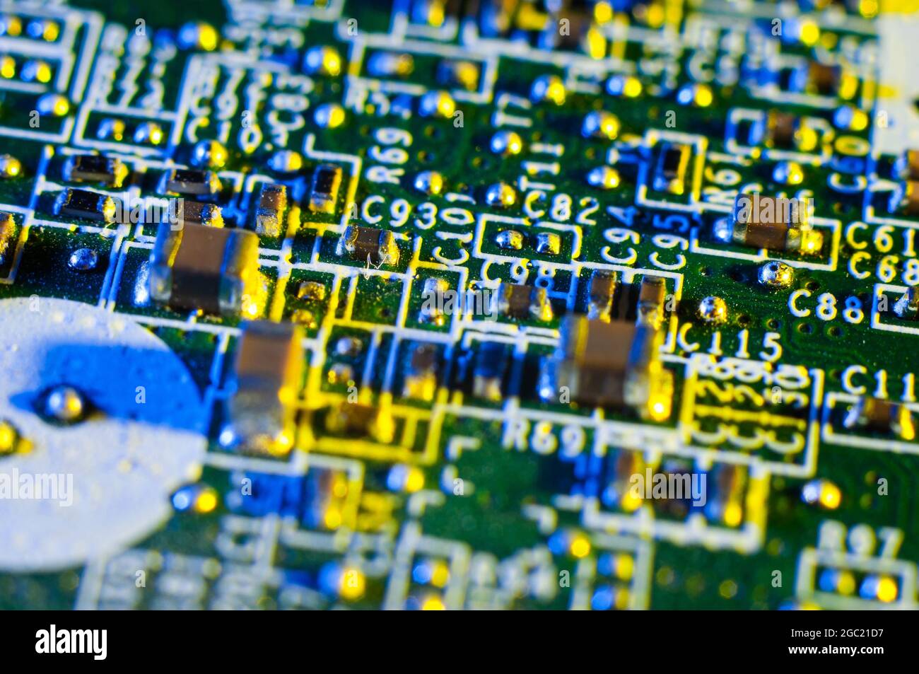 Old electronic circuit board close up in macro photography, blue and ...