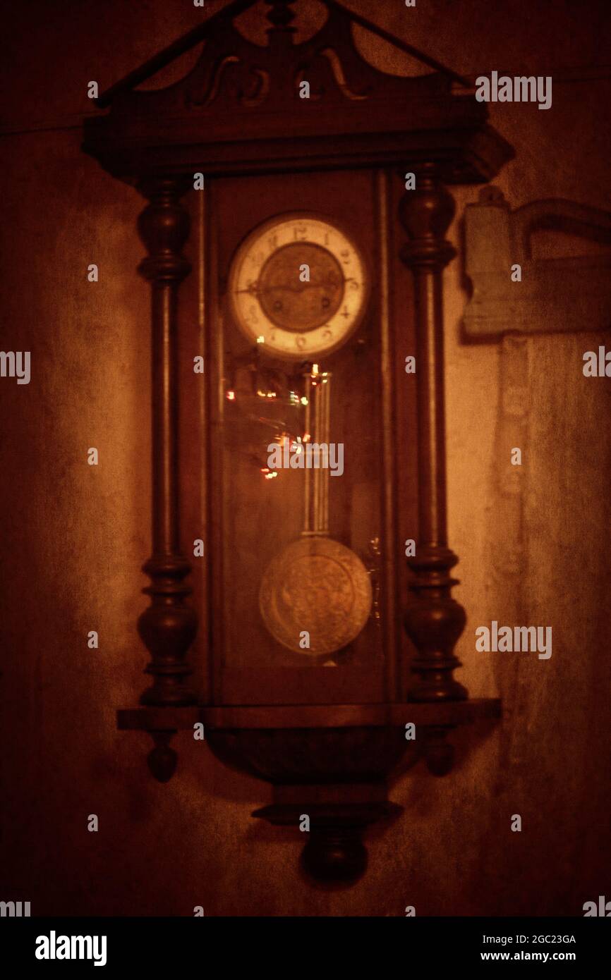 Vintage wooden clock hanging on the wall Stock Photo - Alamy