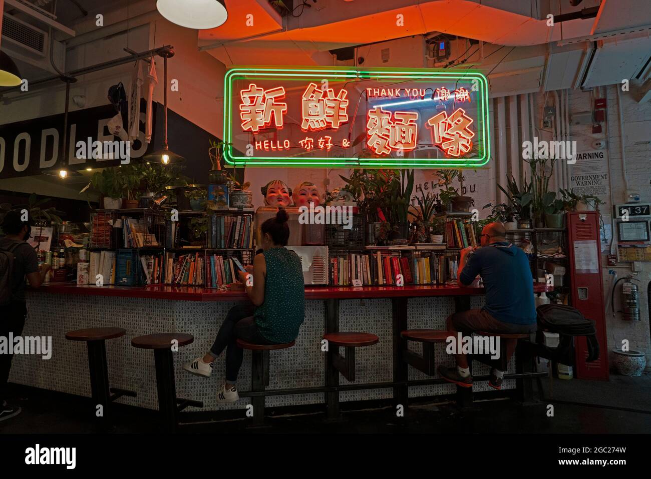 Customers having lunch at a noodle bar in the Chelsea Market, which ...