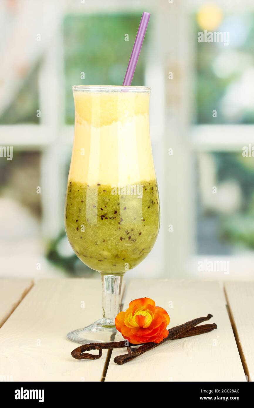 Delicious fruit smoothie on wooden table on window background Stock ...