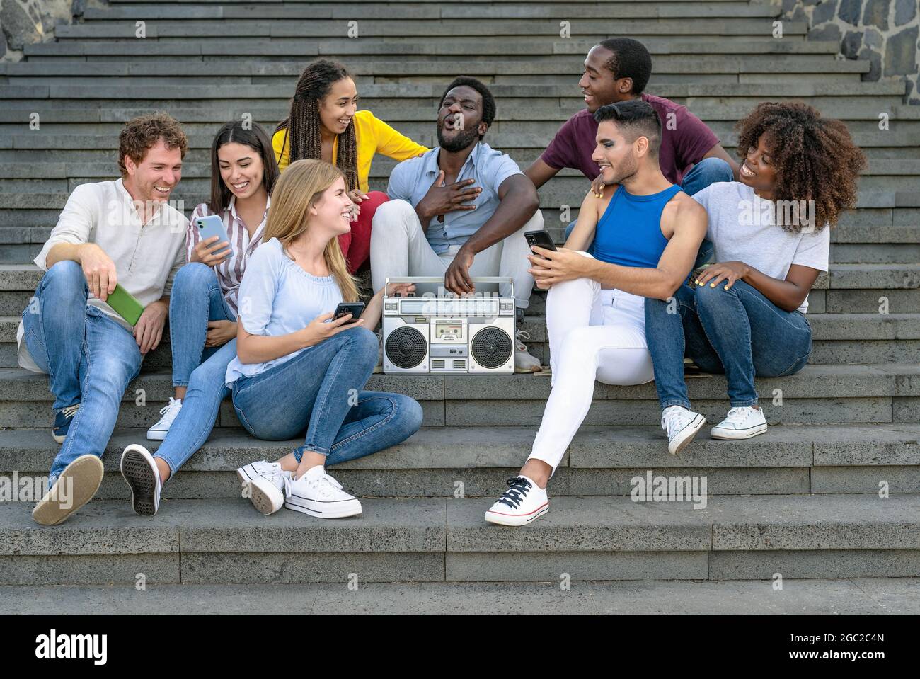 Young Multiracial Friends Having Fun Listening Music With Vintage