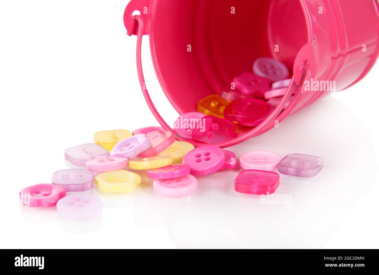 Colorful buttons strewn from bucket isolated on white Stock Photo - Alamy