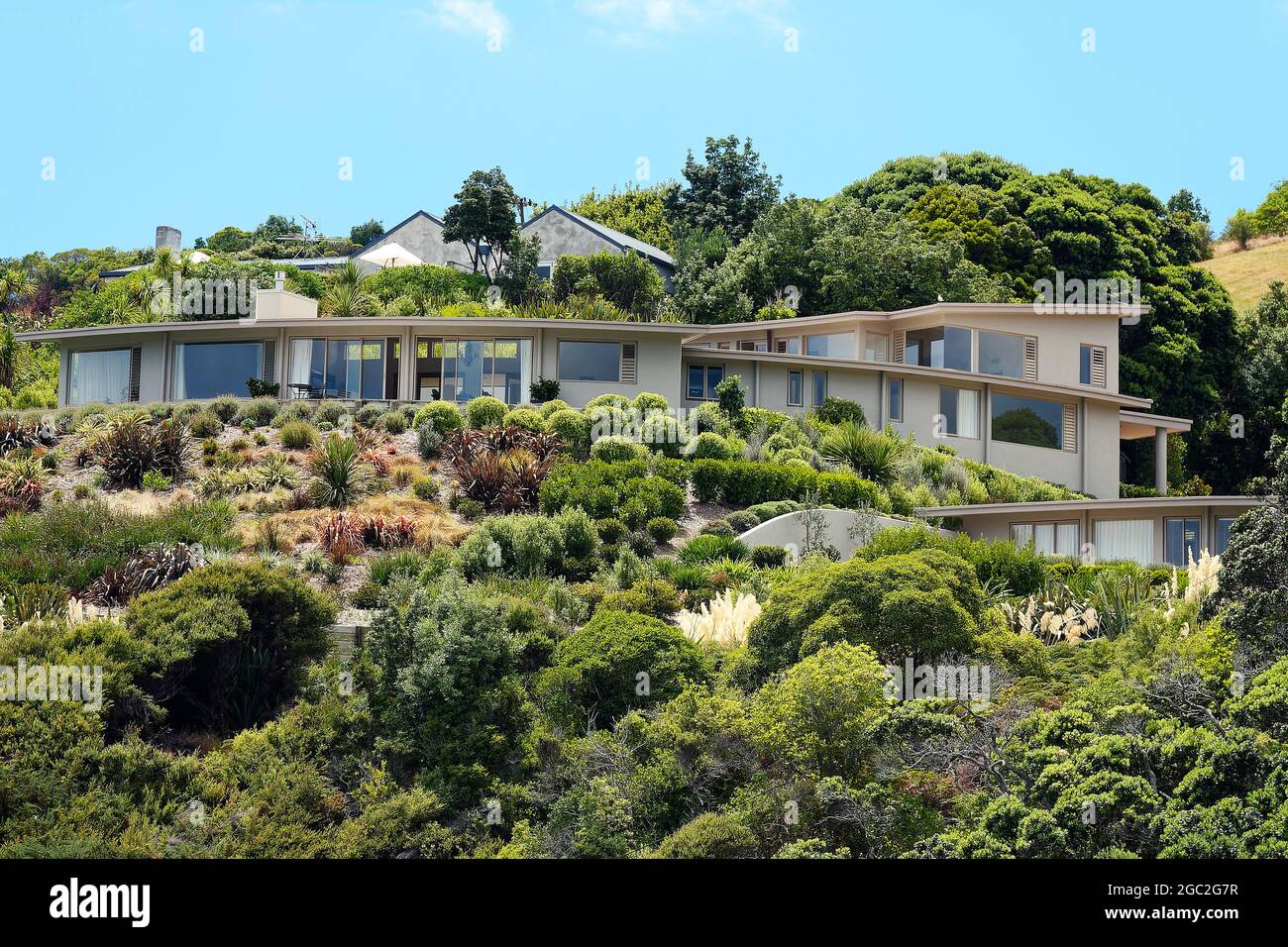 contemporary house, hillside; lush landscaping; glass, multi-level ... contemporary house, hillside; lush landscaping; glass, multi-level ...