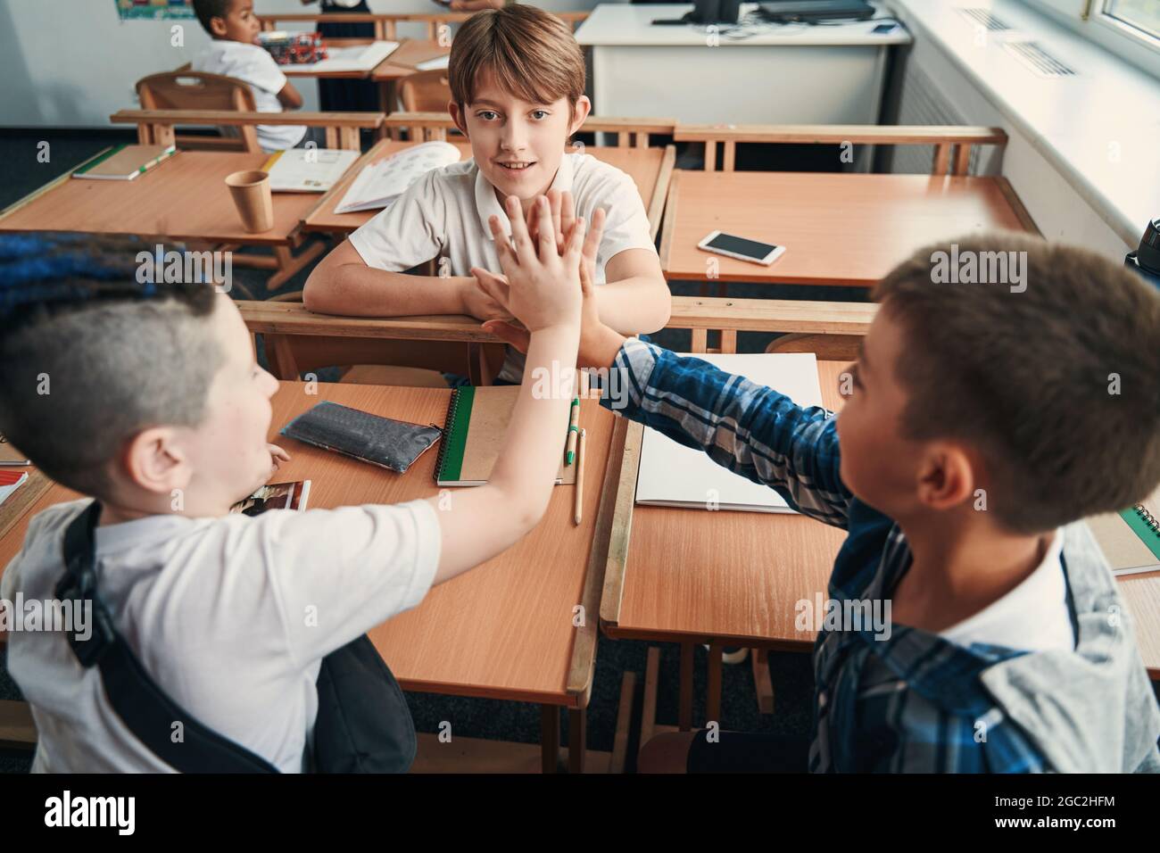 Three friends having good time at school together Stock Photo - Alamy