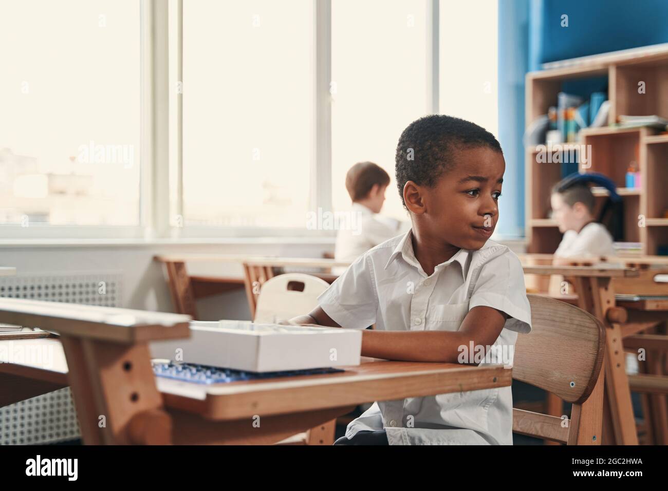Calm boy behaving quietly at the school lesson Stock Photo - Alamy