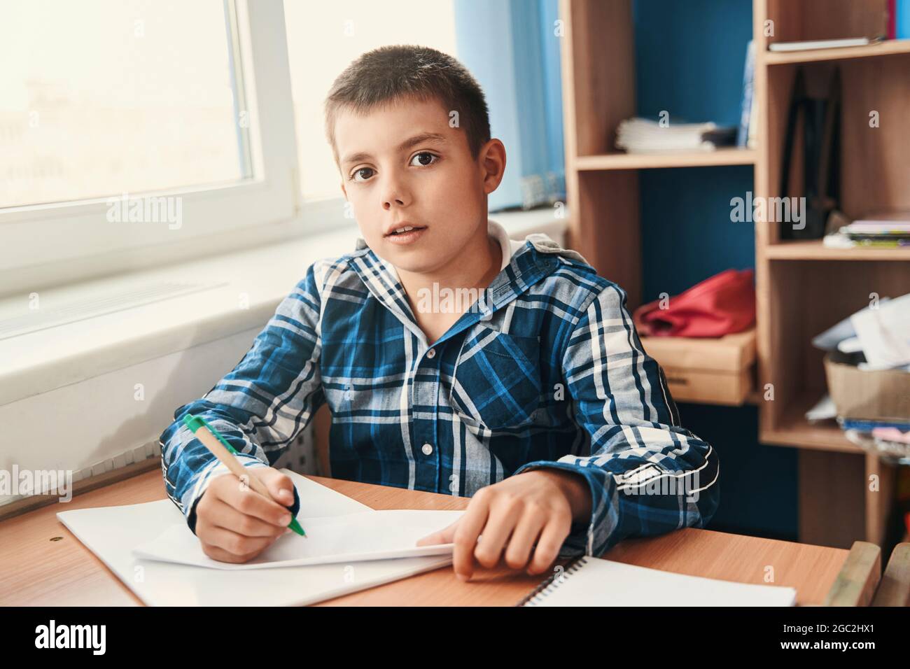 Calm child working hard at the school lesson Stock Photo - Alamy