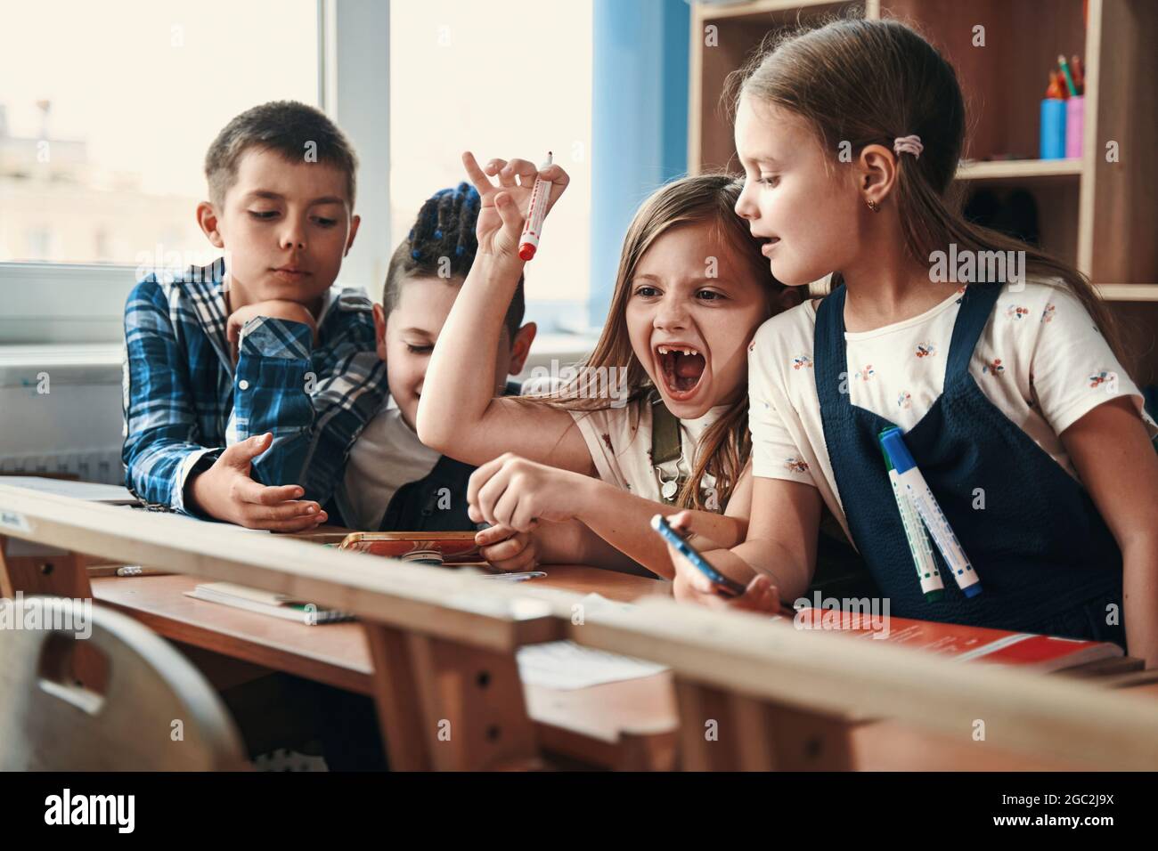 Four funny kids relaxing at the break at school Stock Photo - Alamy