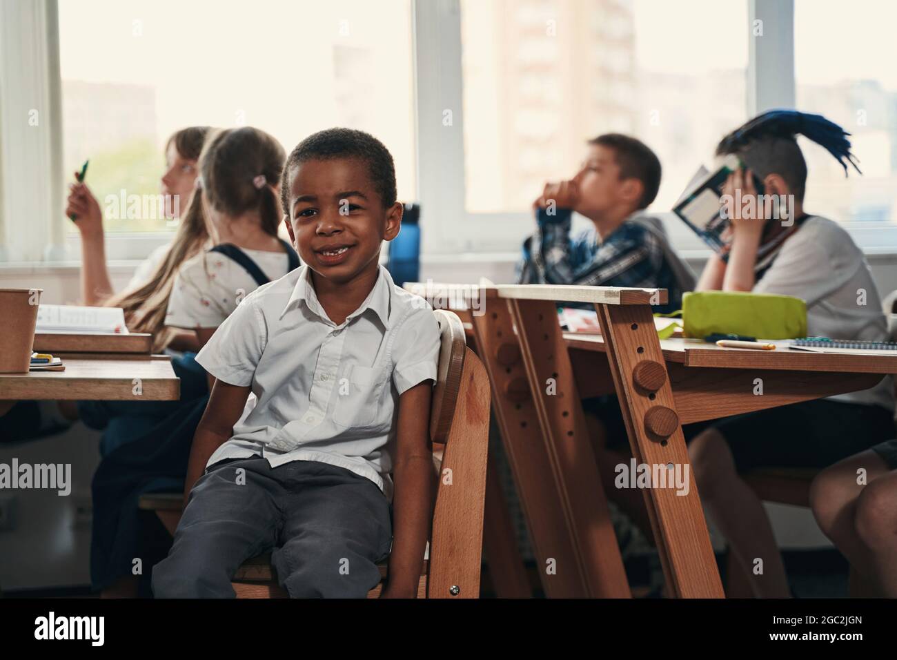 Cute young learner having good time at school Stock Photo - Alamy