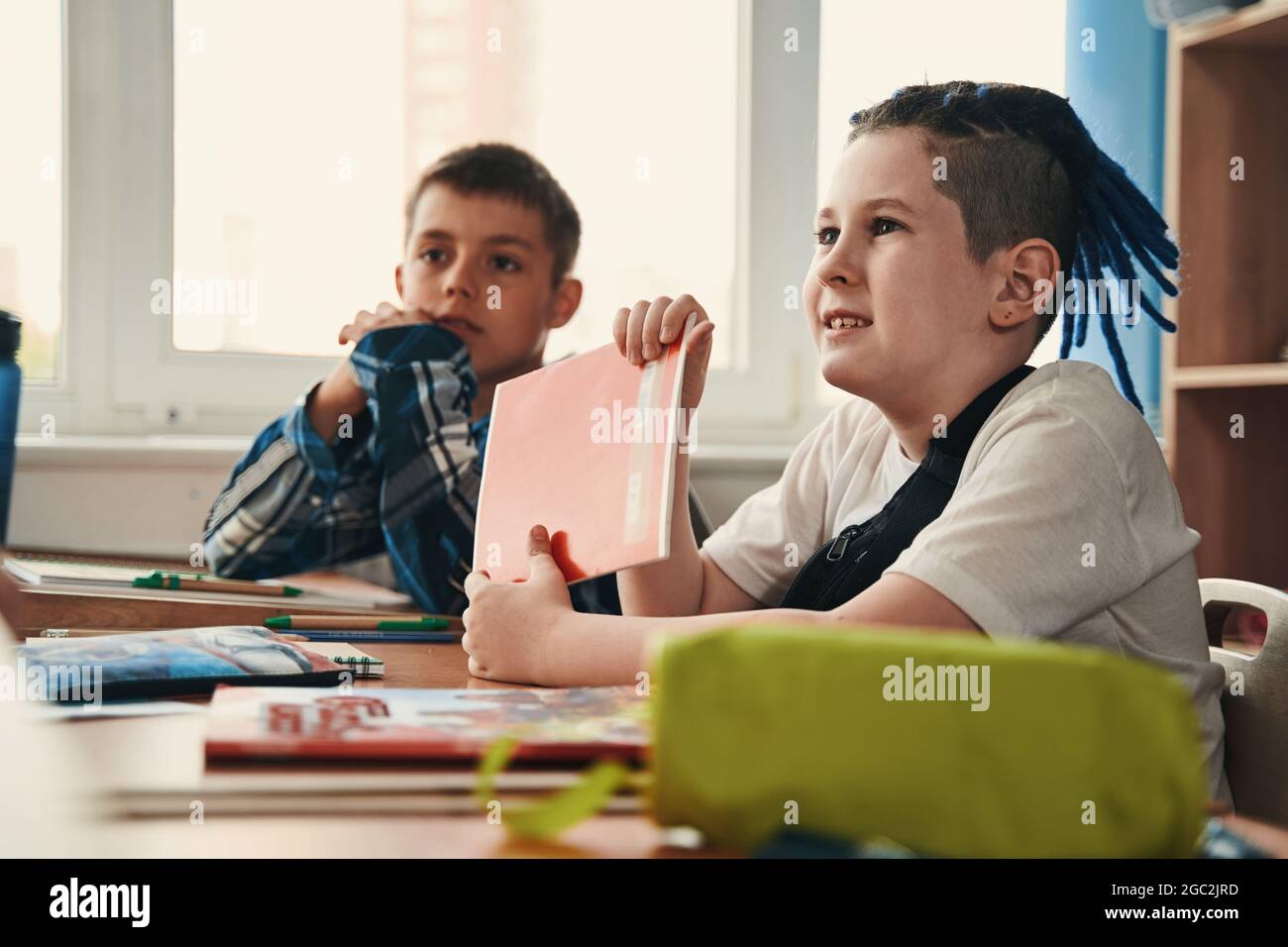 Attentive kids learning new topic and looking interested Stock Photo ...