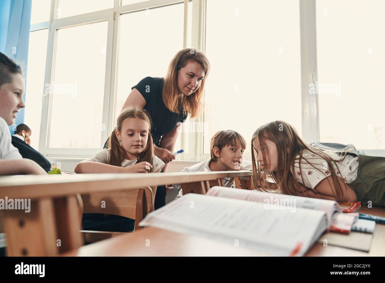 Confident teacher waiting for the answer from her pupils Stock Photo ...