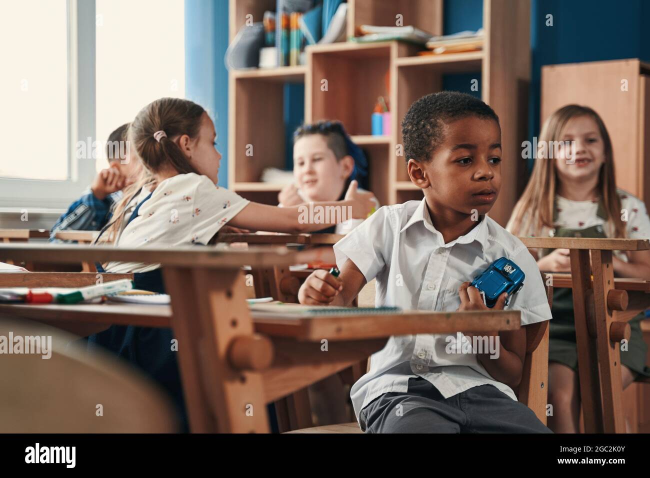 Thoughtful kid with his favorite toy at school Stock Photo - Alamy